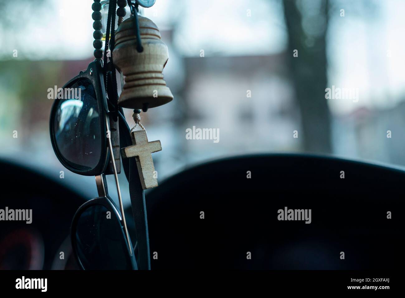 Detail of Crucifix hanging from the mirror in the car Stock Photo - Alamy