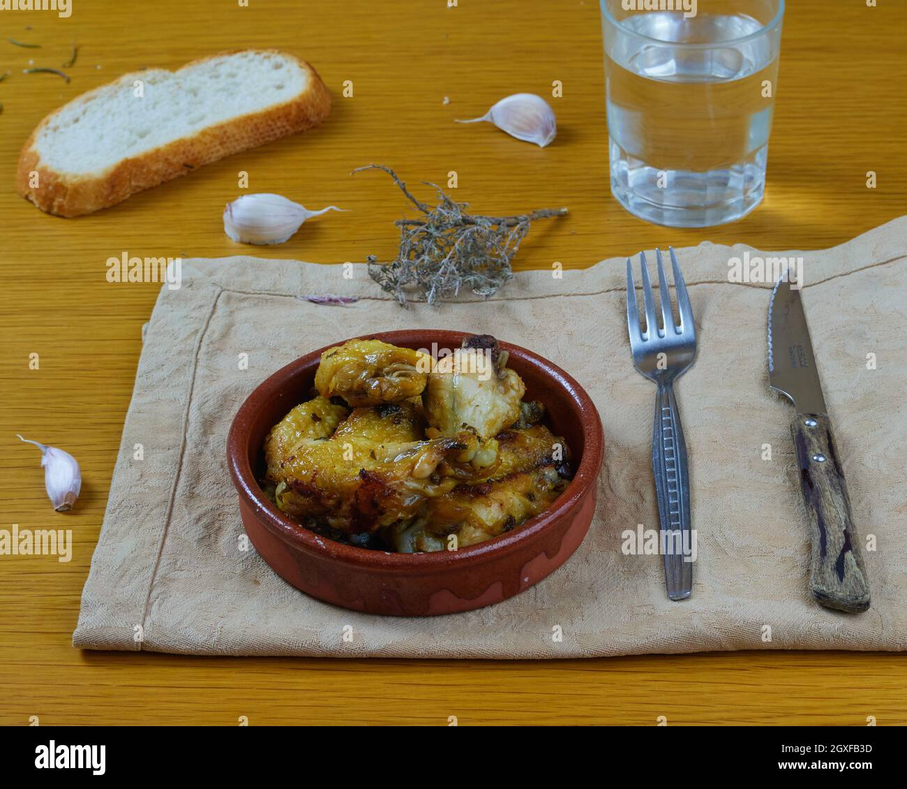 Garlic Chicken Wings (Pollo al ajillo). Spanish Tapa dish in a clay ...