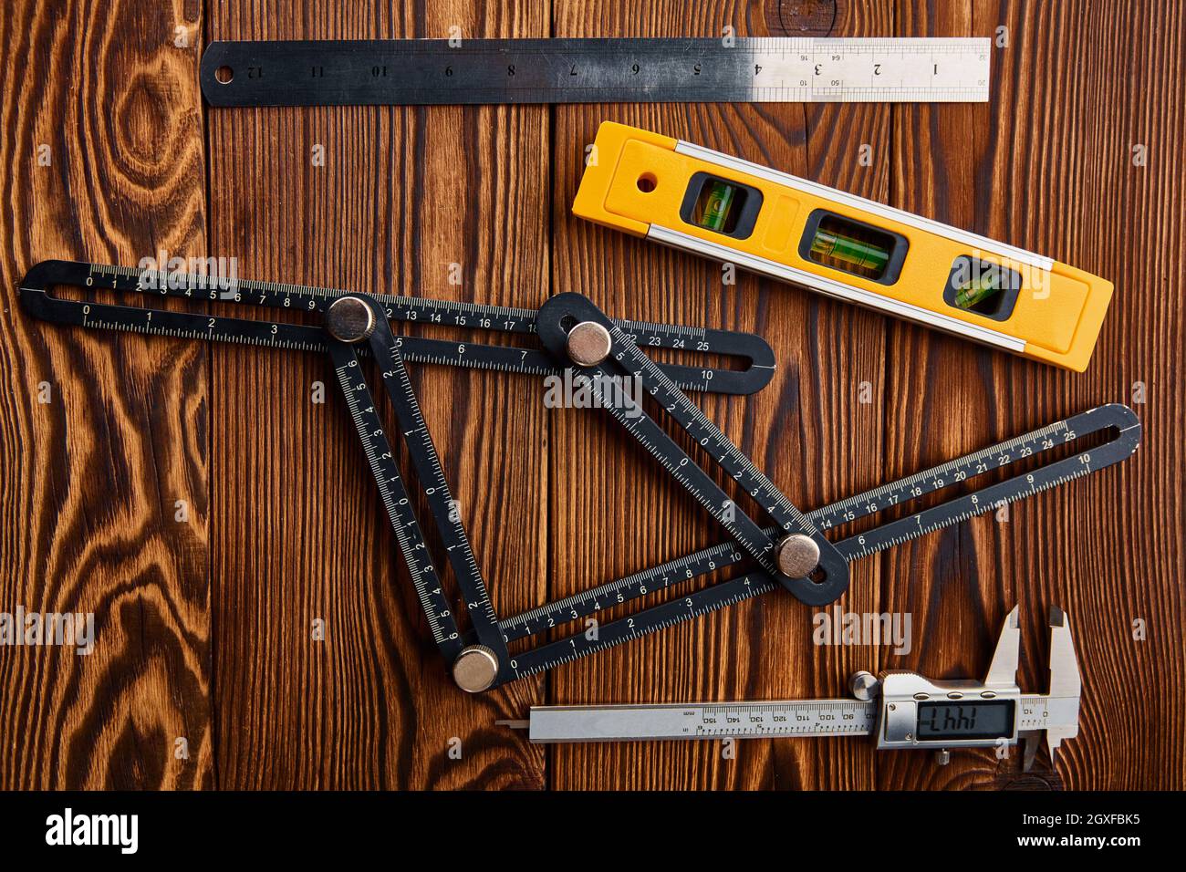 Level, ruler and caliper, wooden background, nobody. Professional ...