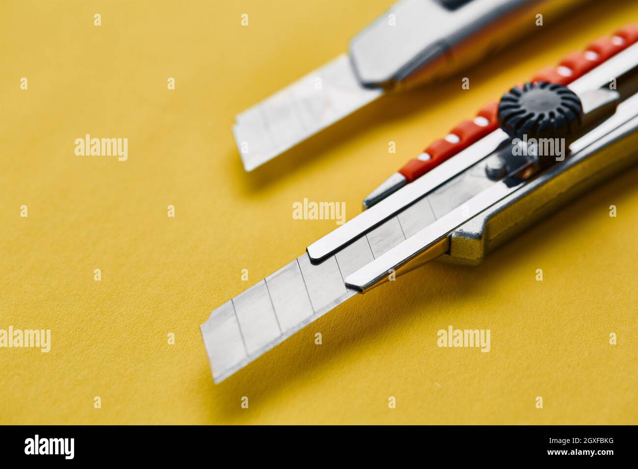 Razor, construction knife, yellow background, nobody. Professional ...