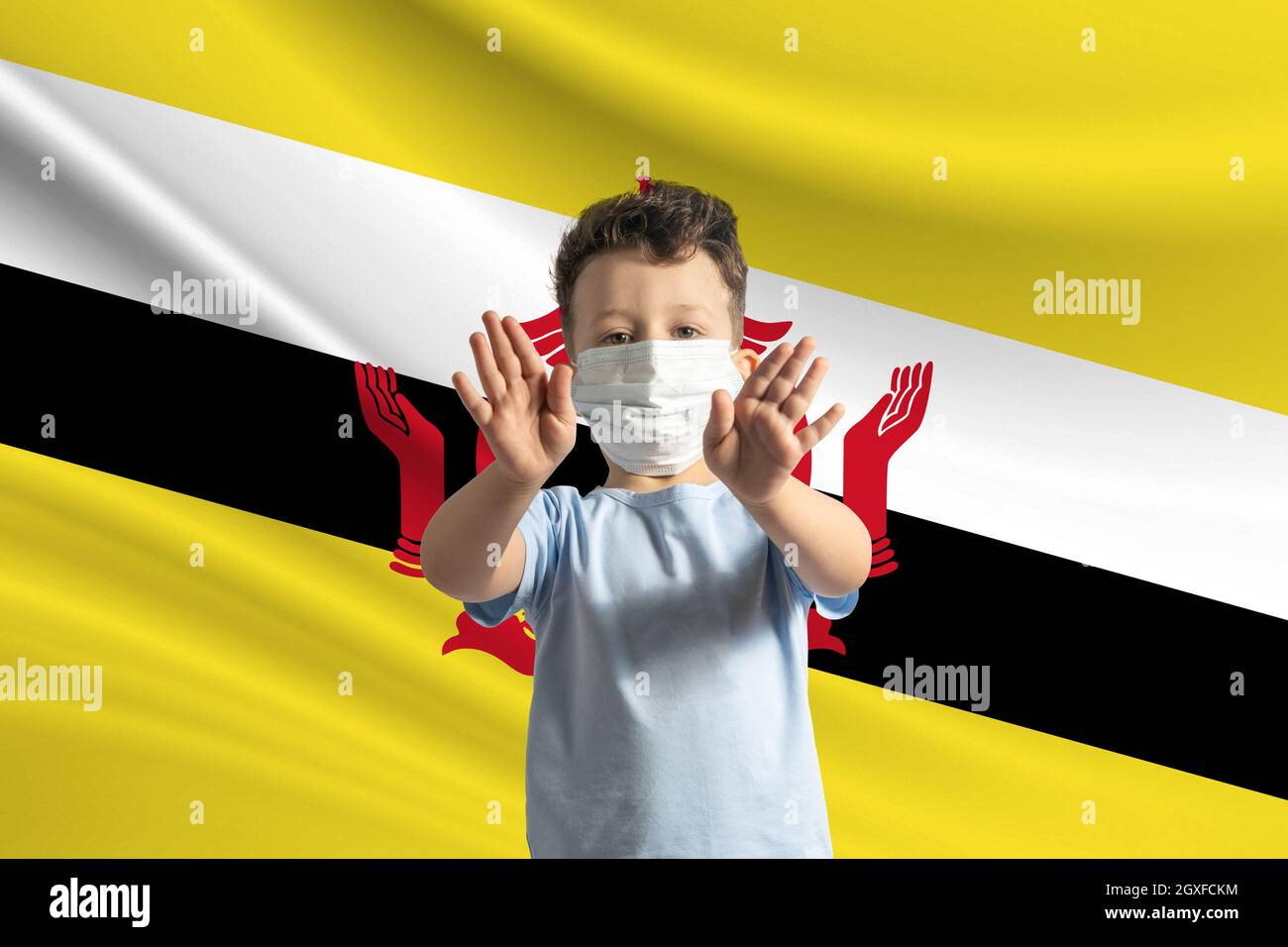 Little white boy in a protective mask on the background of the flag of ...
