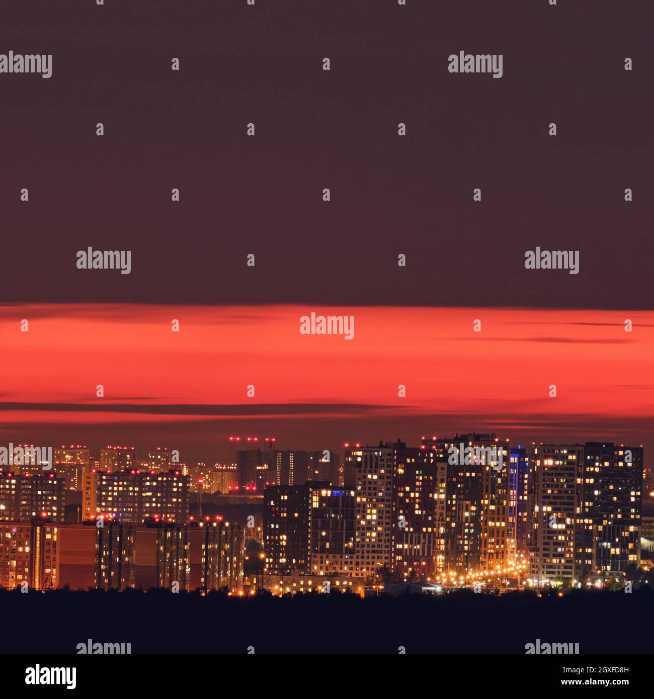 Night city lights at dusk sunset, red sky over houses Stock Photo - Alamy
