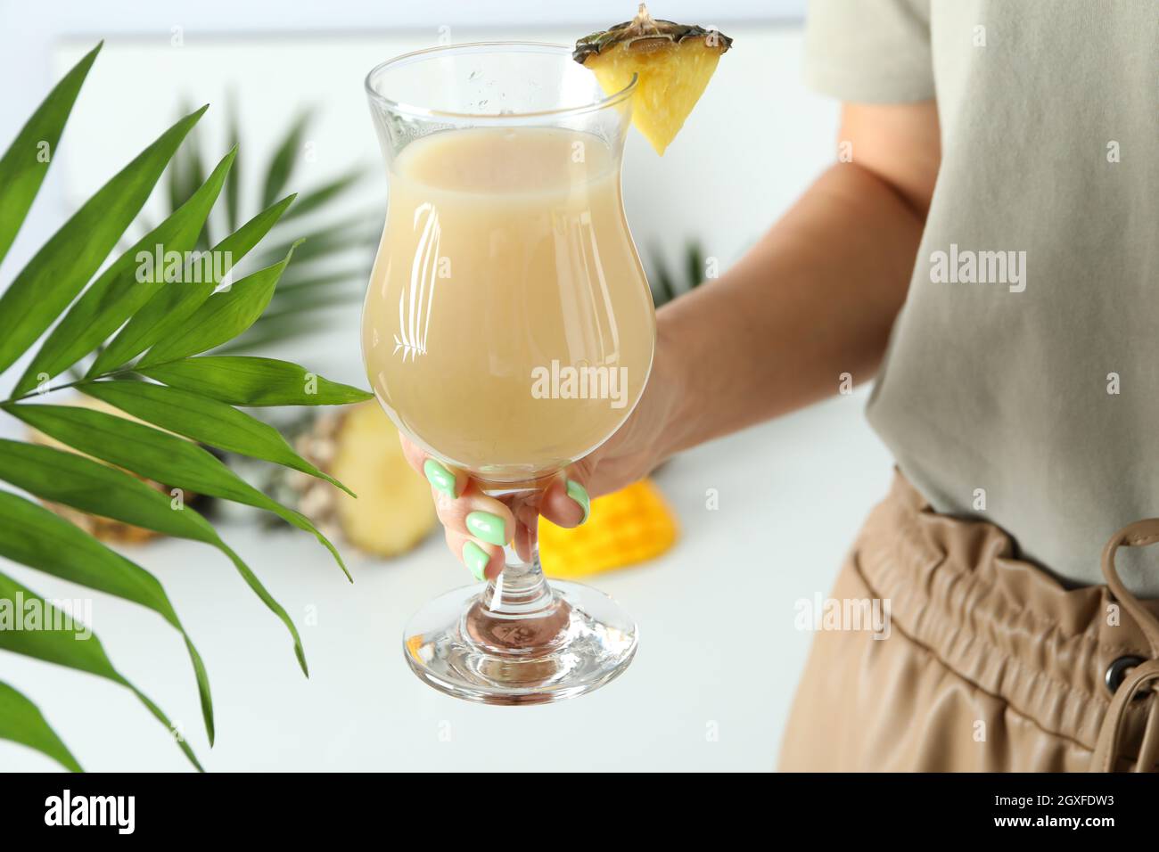 Woman holds pina colada cocktail, close up Stock Photo - Alamy