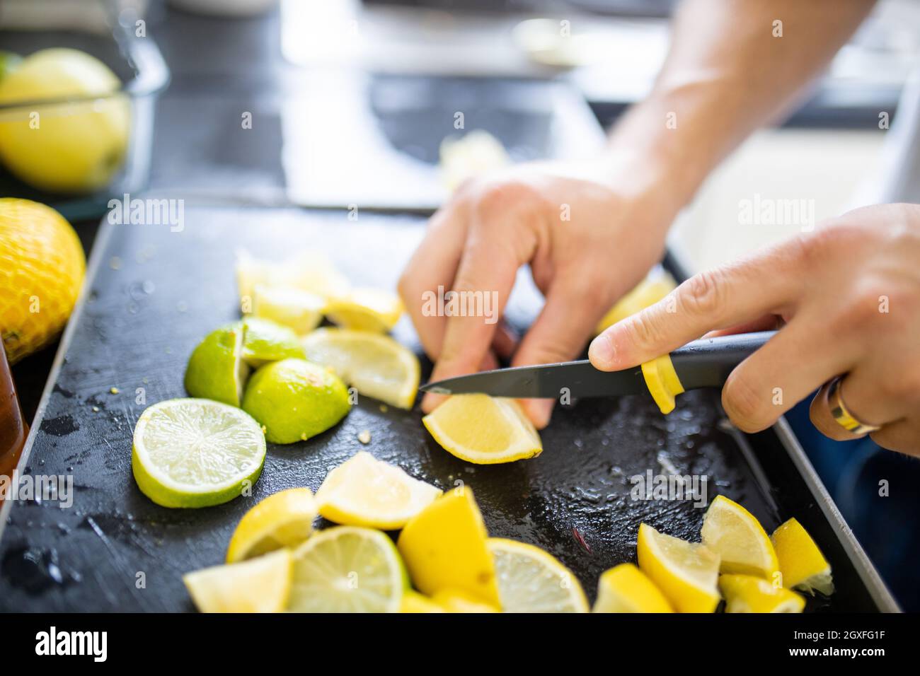 Man cutting juicy lemon fruit hi-res stock photography and images - Alamy