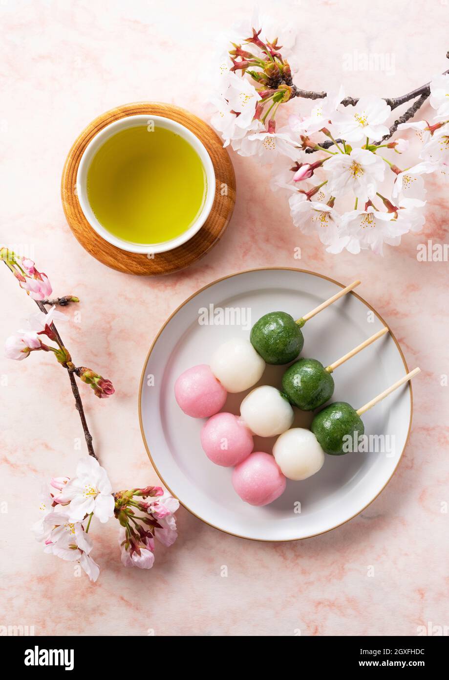 Sanshoku dango placed on a pink background. An image of Japanese spring ...