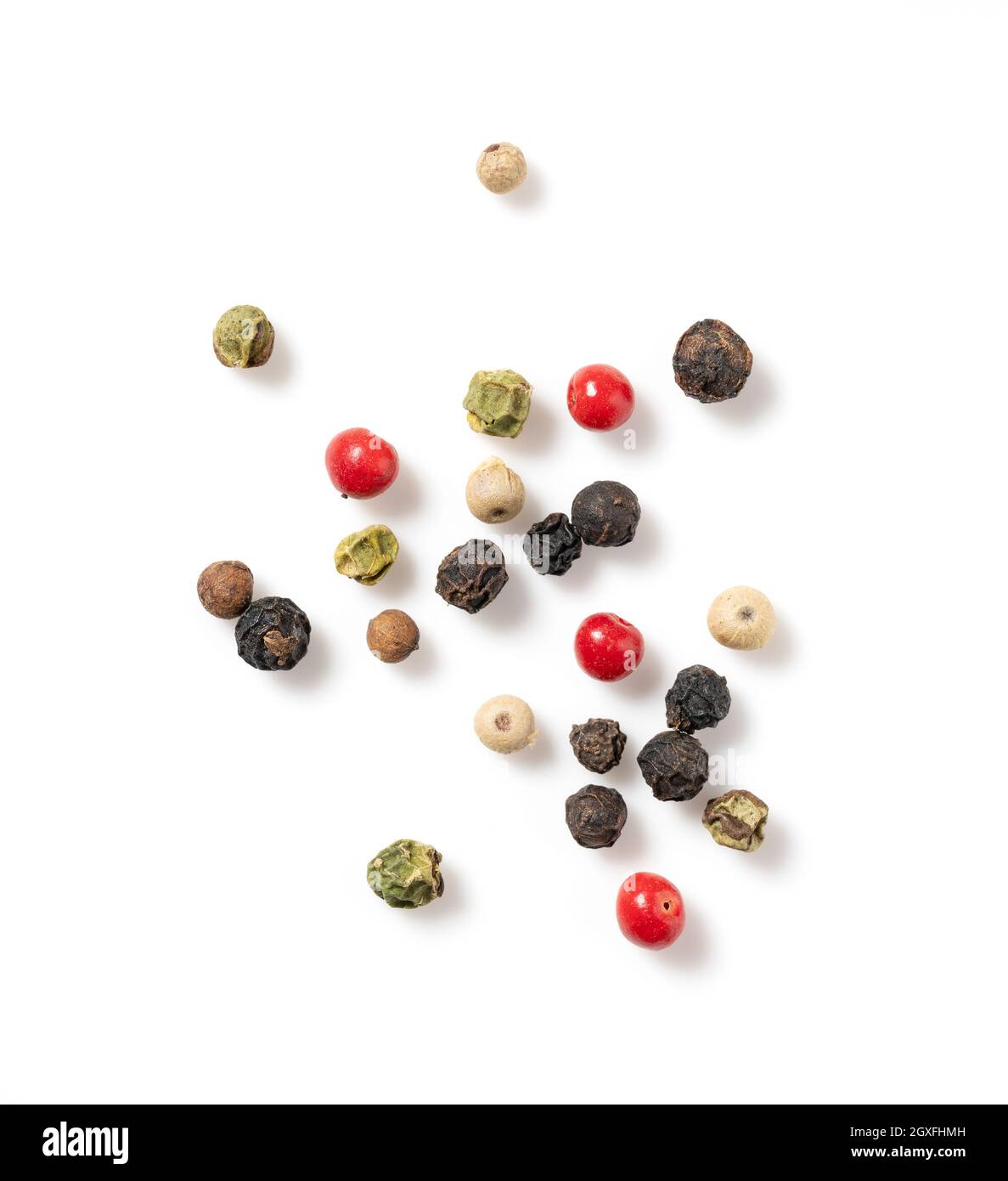Pepper mix. Black, red, white, and green peppercorns on a white ...