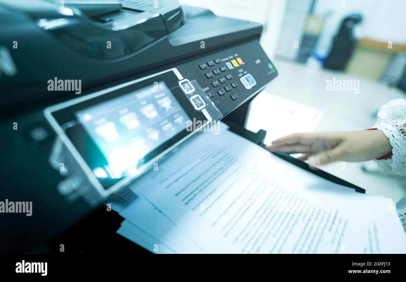 Office worker print paper on multifunction laser printer. Copy, print ...