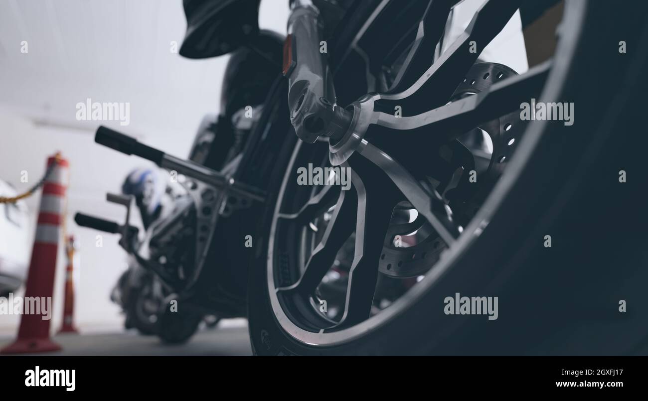 Closeup aluminum alloy wheel of motorcycle parked at car parking lot ...
