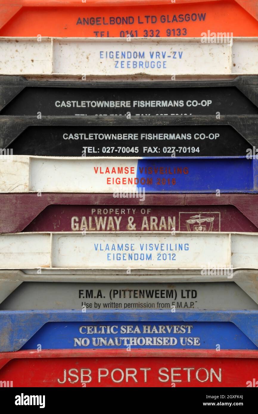 Various plastic fish boxes for use by commercial fishermen Stock Photo ...