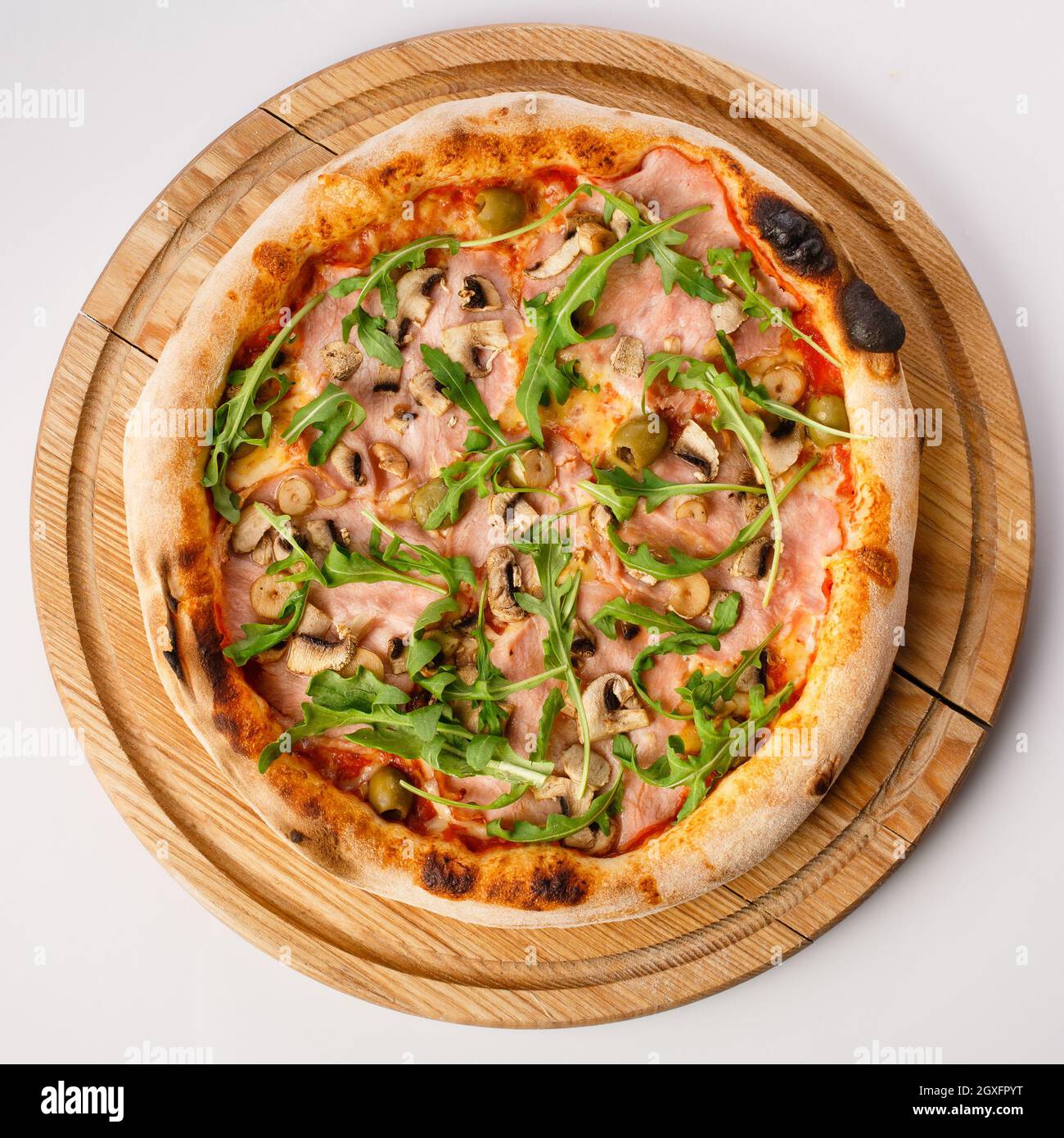 Top view of hot pizza on a wooden stand. Pizza Capricciosa , tomato ...