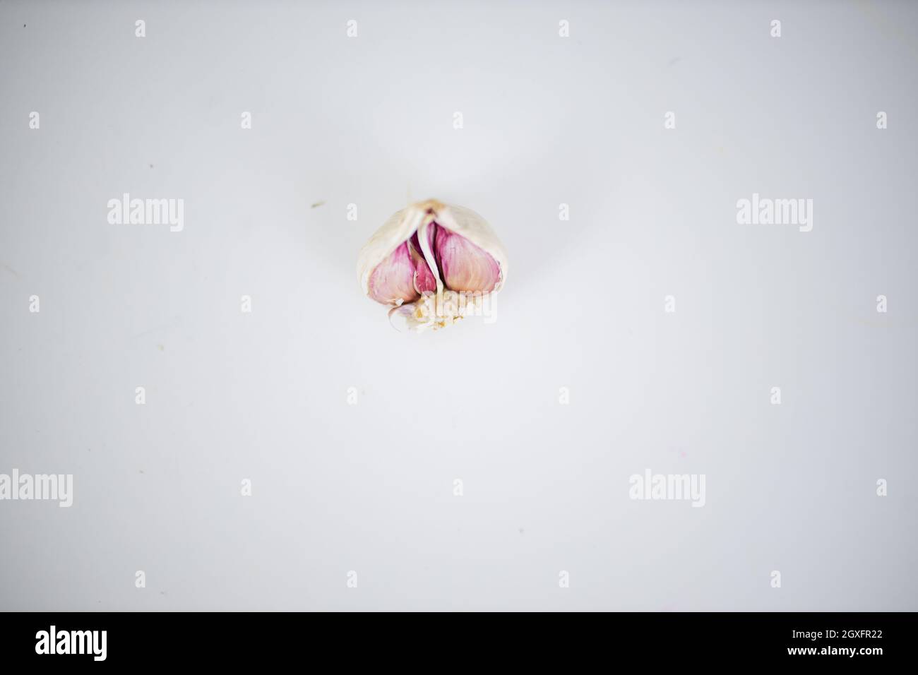 Fresh half a garlic isolated on white table from above. Top view of ...