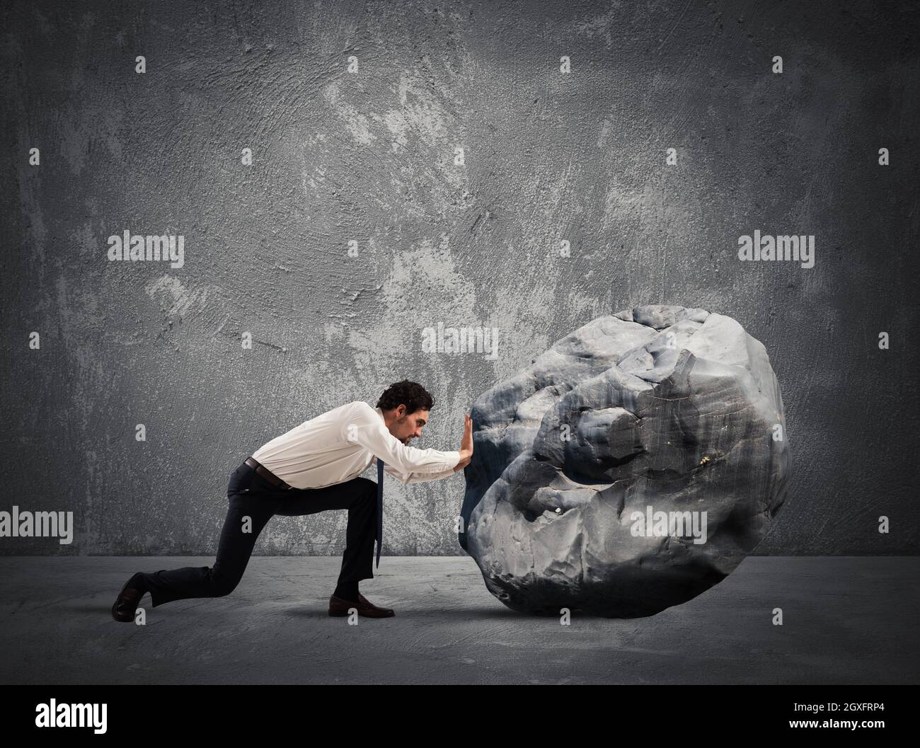 Businessman pushing a heavy boulder with great effort Stock Photo - Alamy
