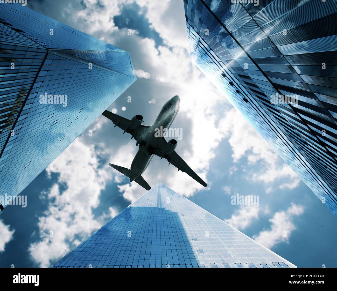 Aircraft fly in the sky between skyscrapers Stock Photo - Alamy