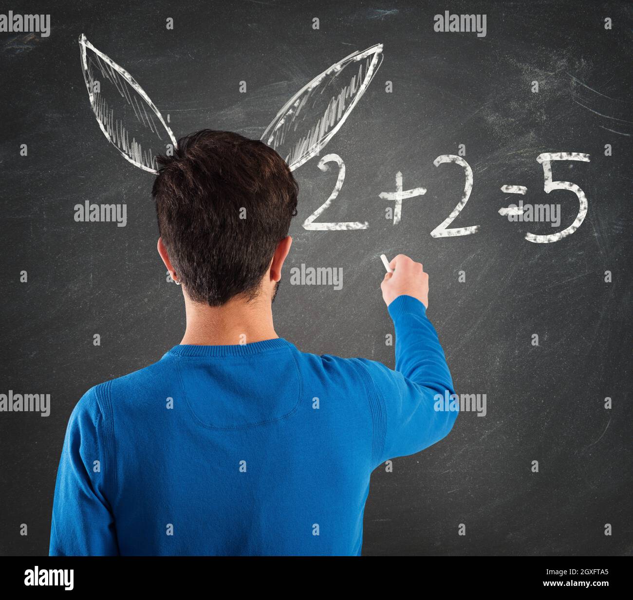 Student with donkey ears writes math operation Stock Photo - Alamy
