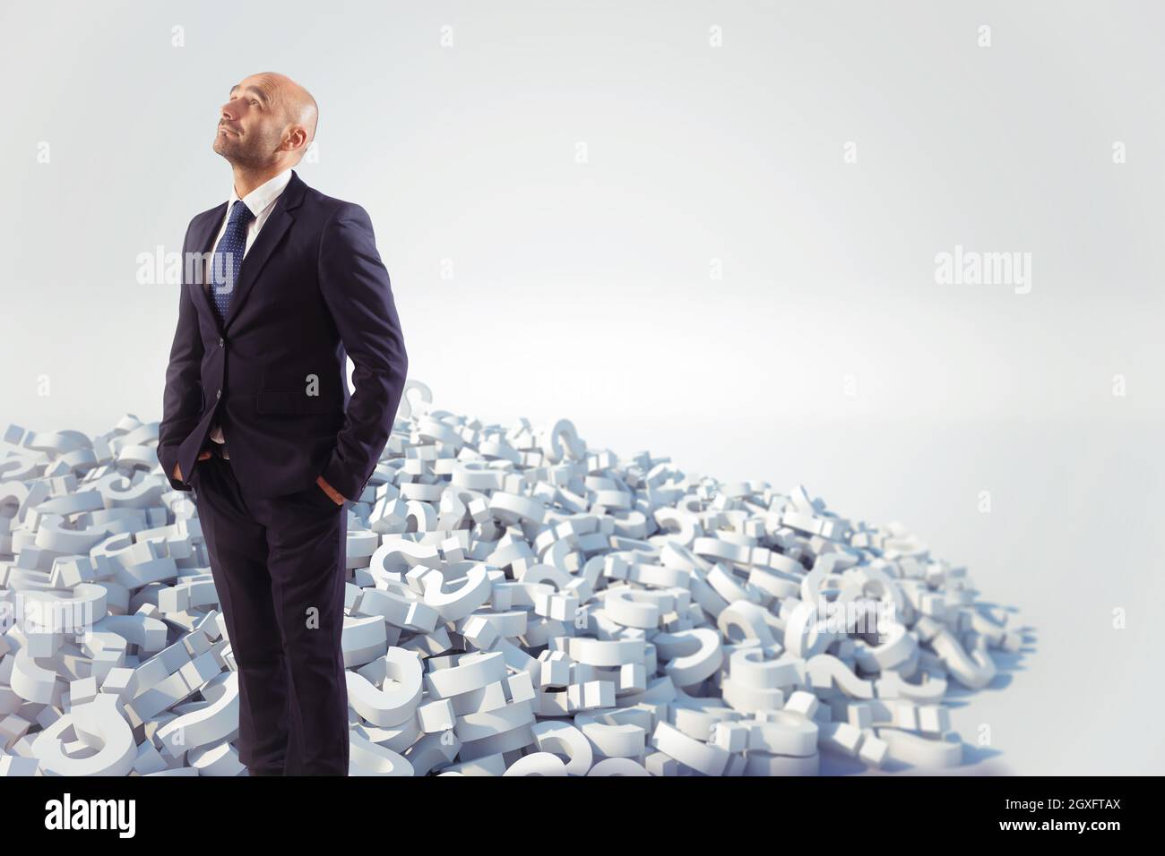 Businessman with a white question marks stack Stock Photo - Alamy