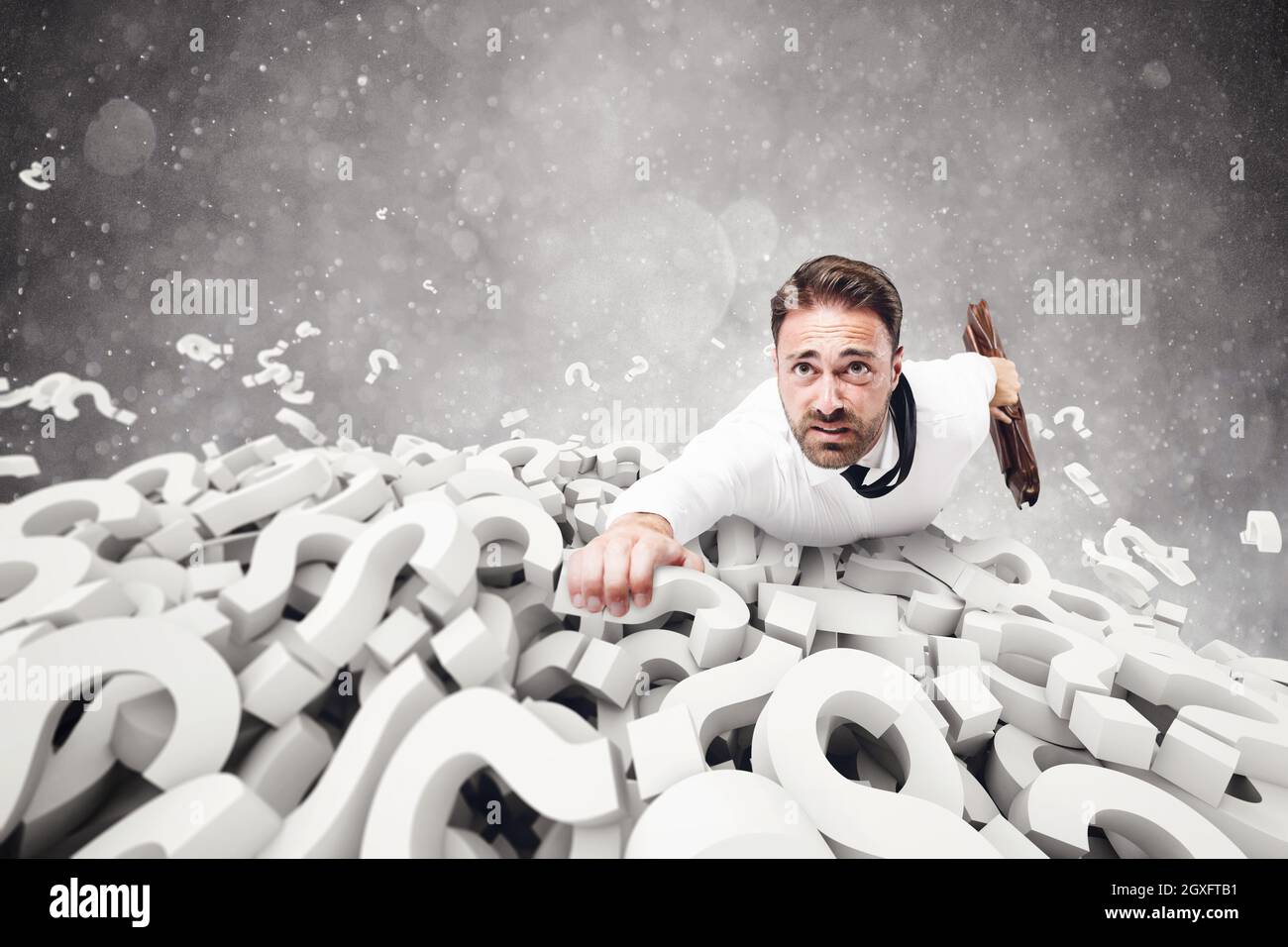 Afraid businessman clinging to question marks pile Stock Photo - Alamy