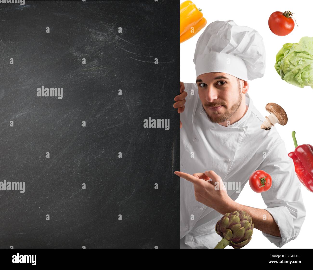 Smiling chef with blackboard and vegetables background Stock Photo - Alamy
