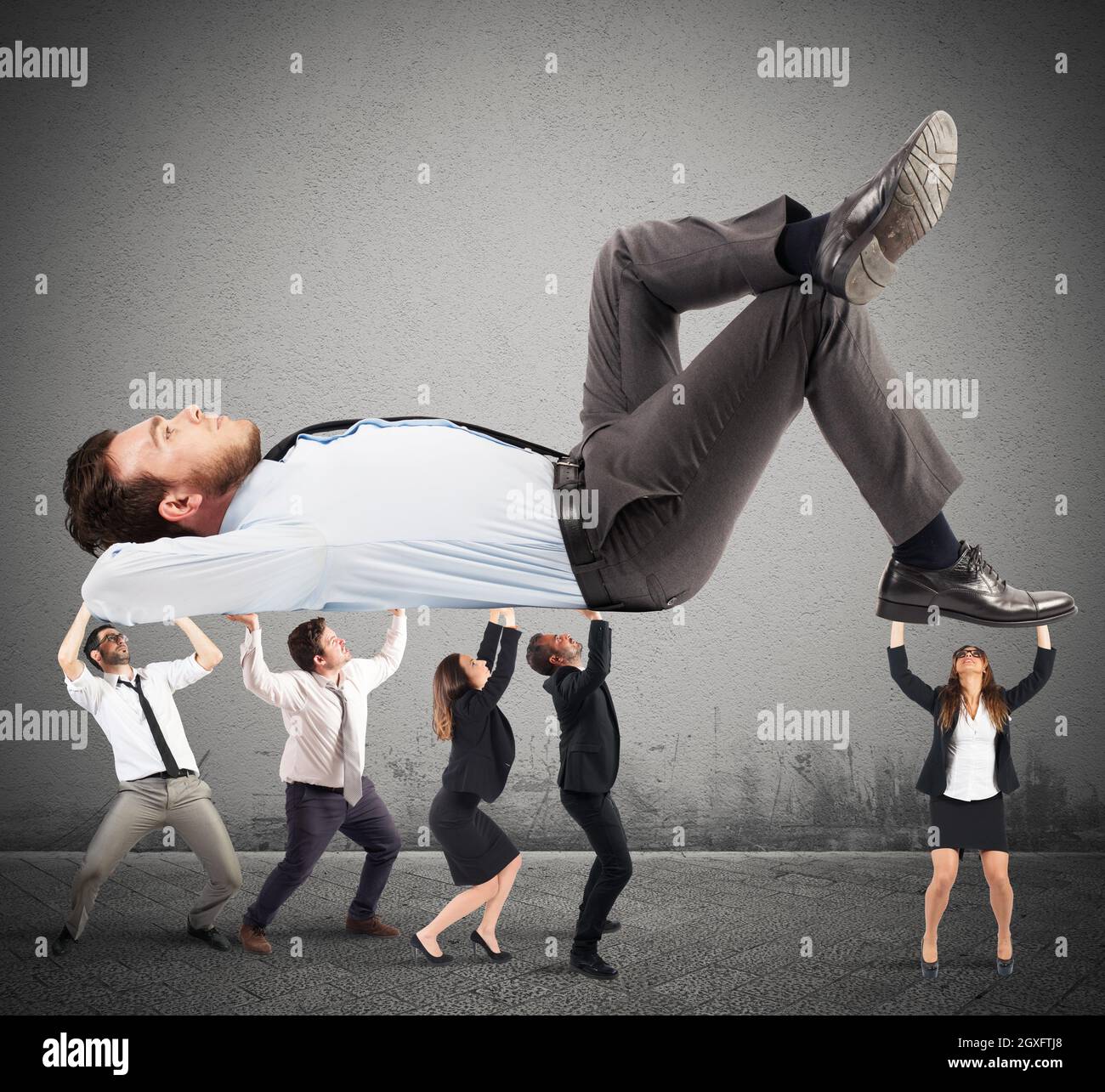 Men and women support a big man Stock Photo - Alamy