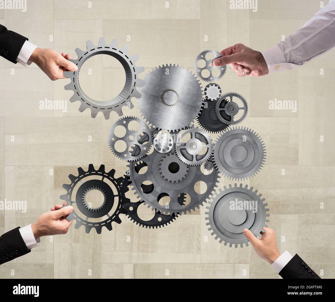 Teamwork of businesspeople work together and combine pieces of gears to ...