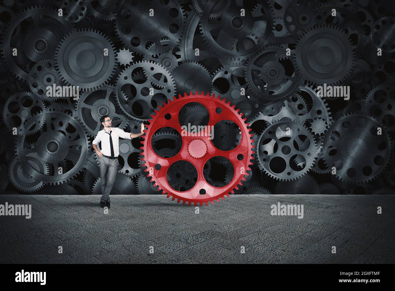 Businessman builds a business system as a gears mechanism and puts the ...