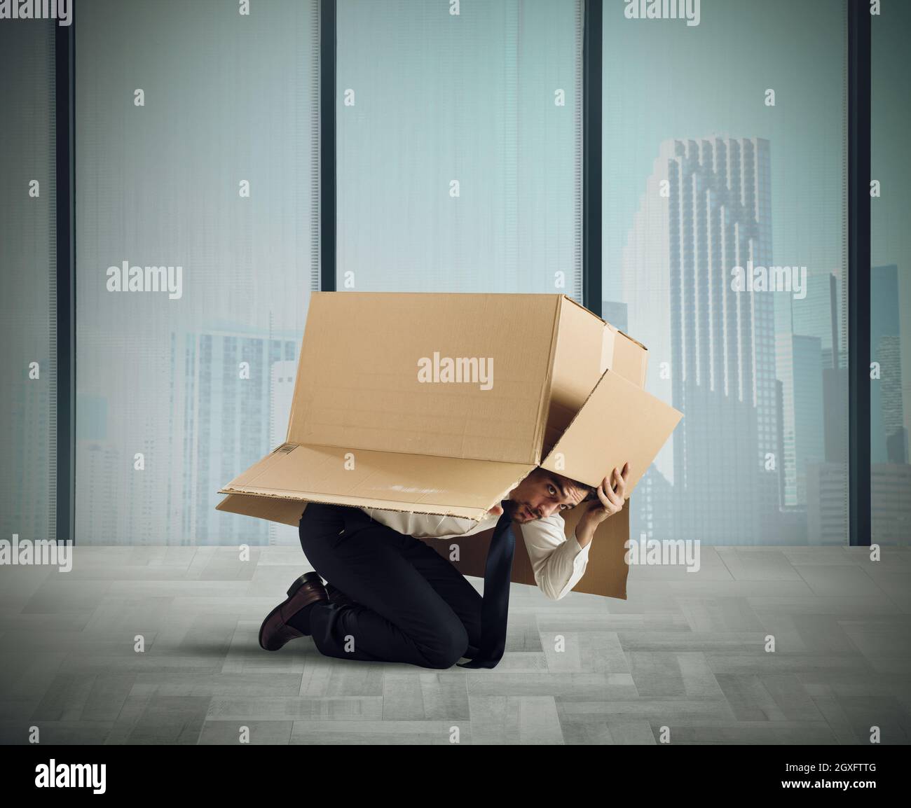 Afraid businessman is hiding under a cardboard Stock Photo - Alamy