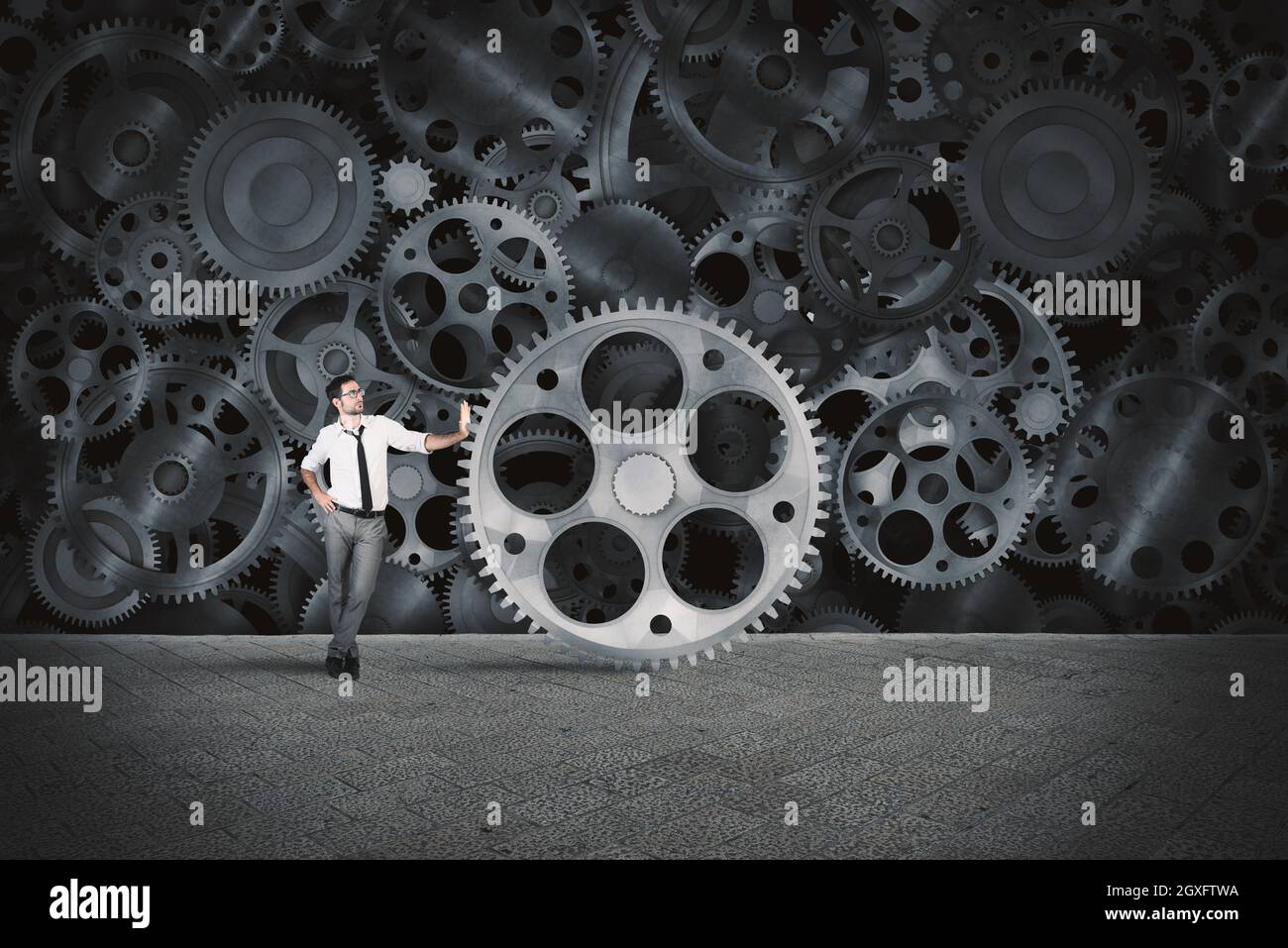 Businessman builds a business system as a gears mechanism and puts the ...