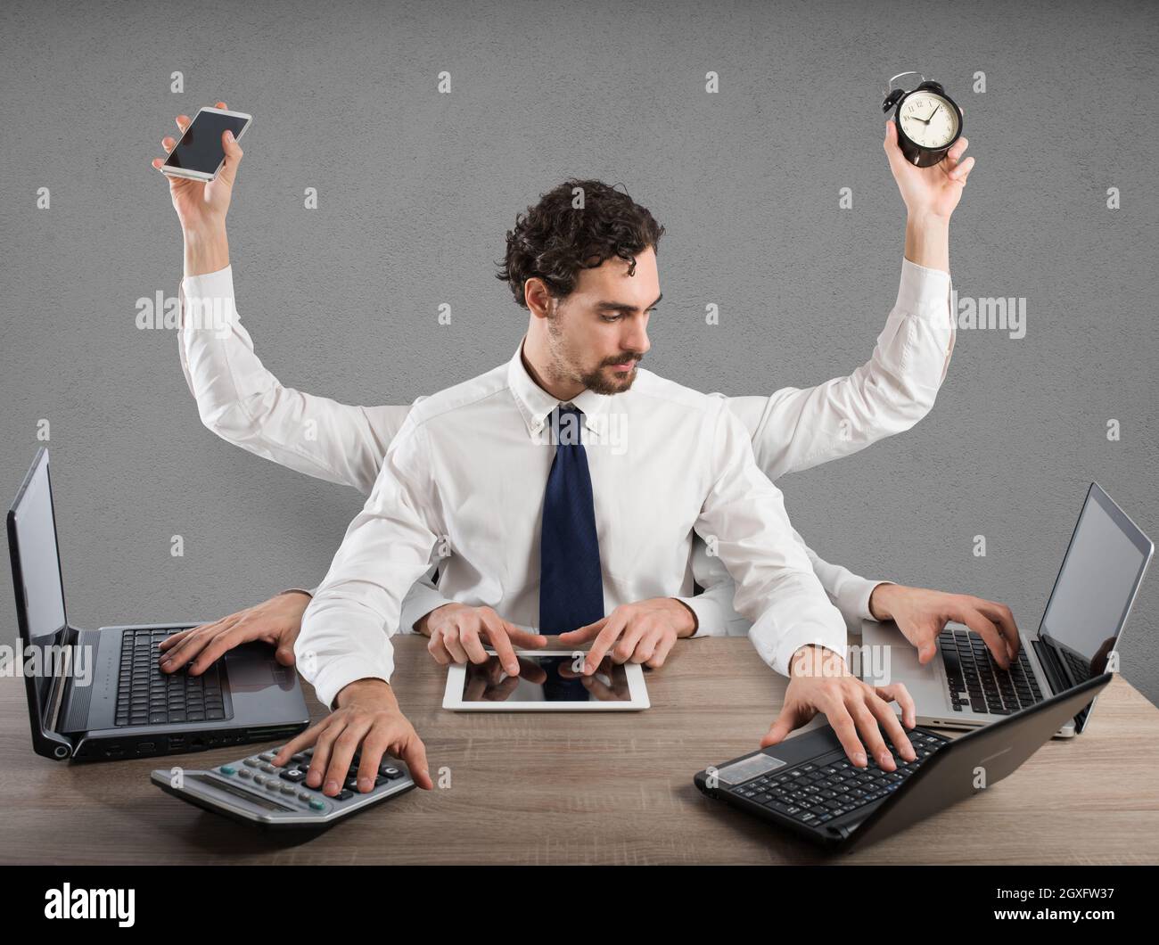 Businessman stressed by too many tasks works in the office Stock Photo ...