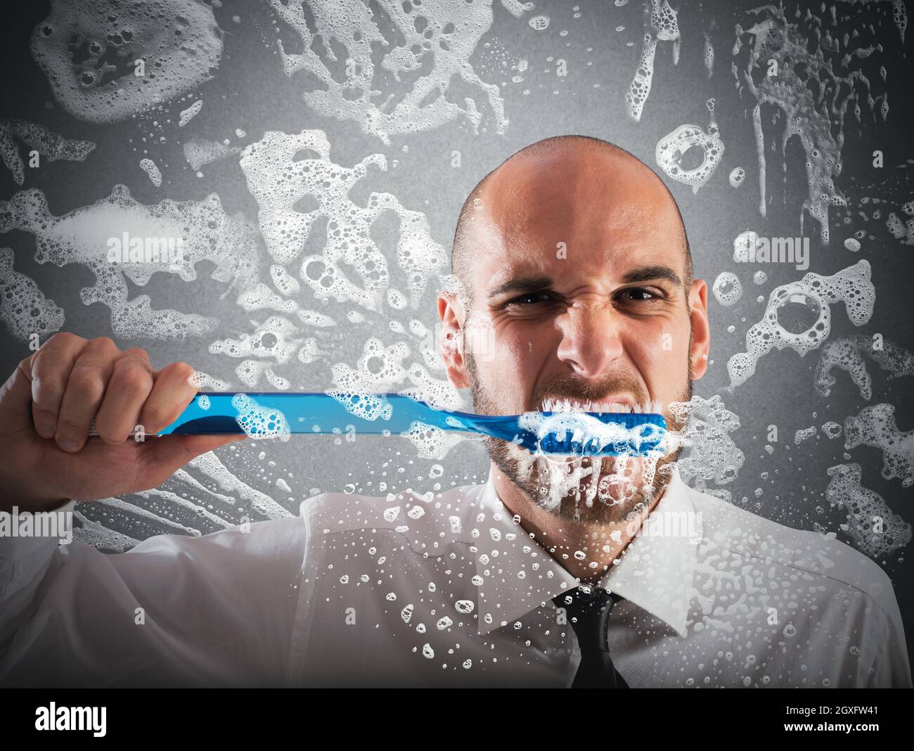 Man brushing teeth with a big toothbrush Stock Photo - Alamy
