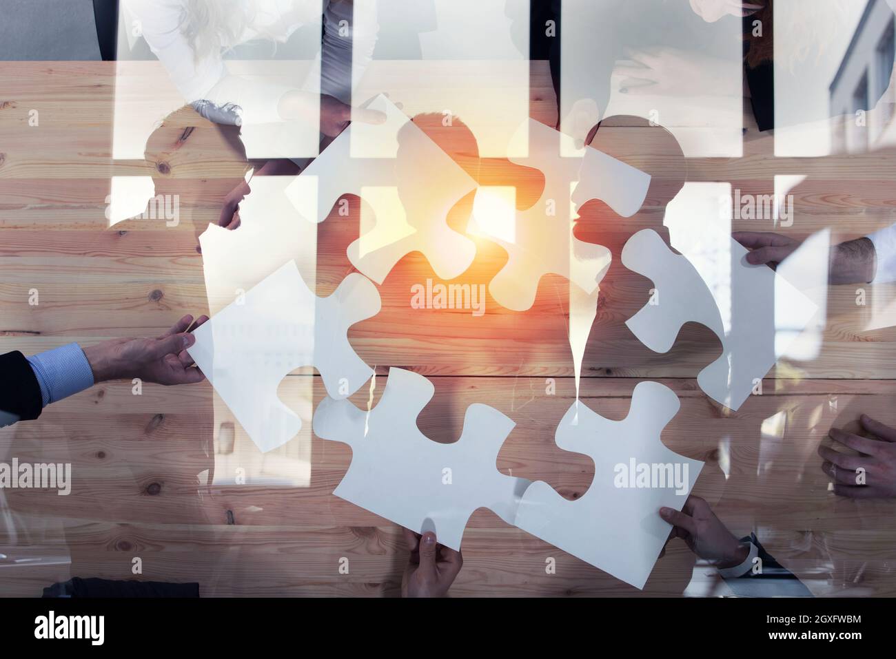 Business people work together in office to build a puzzle. Concept of teamwork, partnership ...