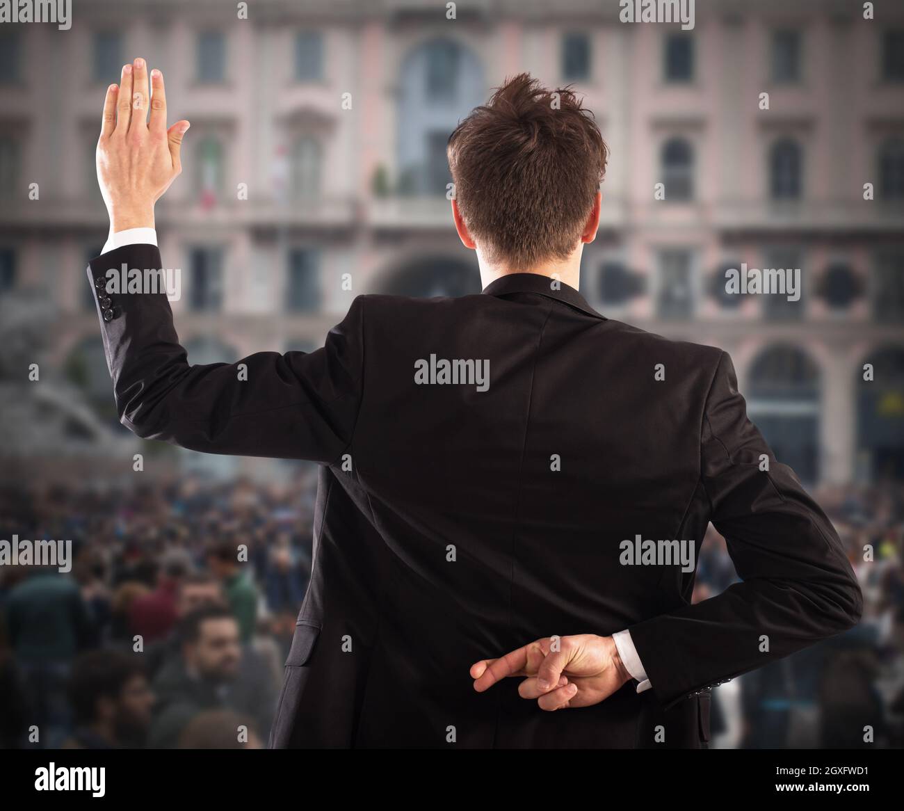 Man makes gesture with hand behind back Stock Photo - Alamy