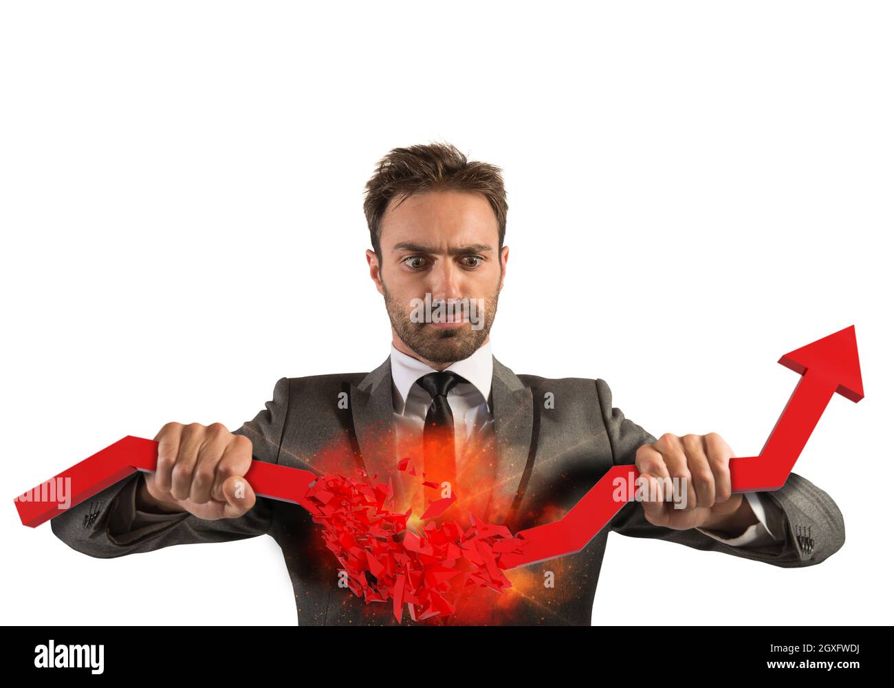 Angry businessman breaks a big red arrow Stock Photo - Alamy