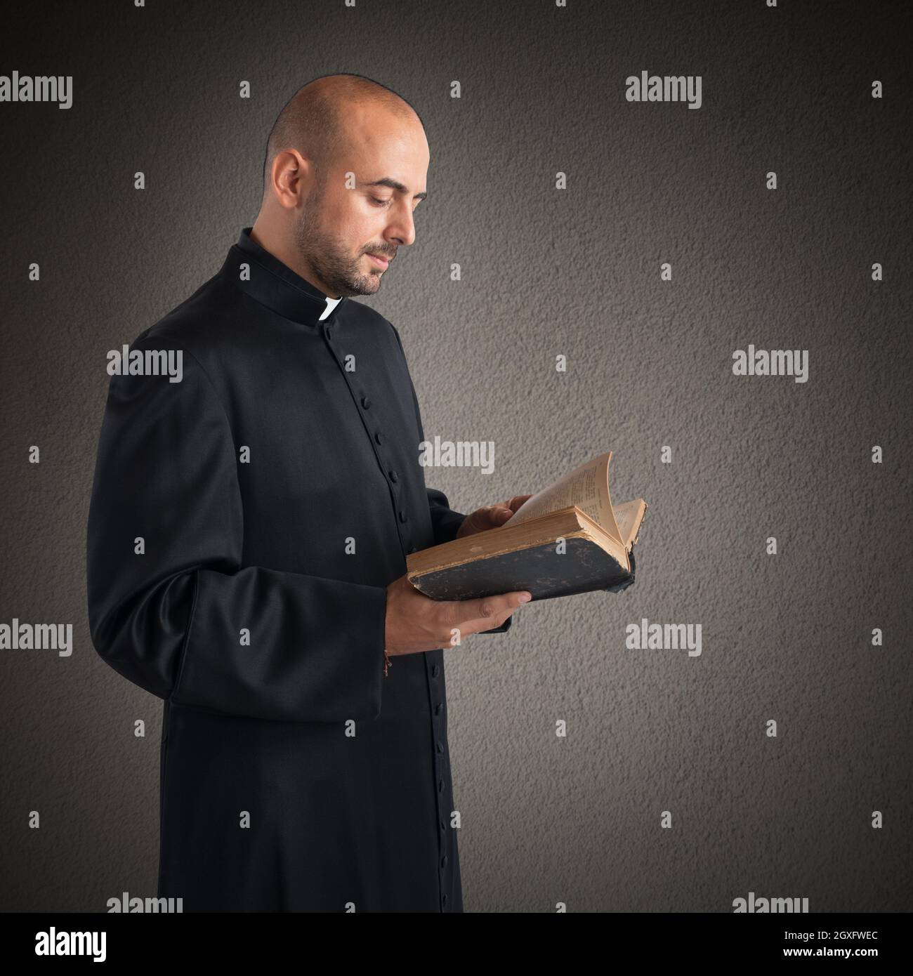Man priest reads the bible sacred text Stock Photo - Alamy