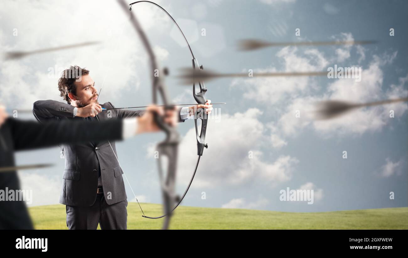 Businessmen in a competition with the arc and arrows to reach and hit ...