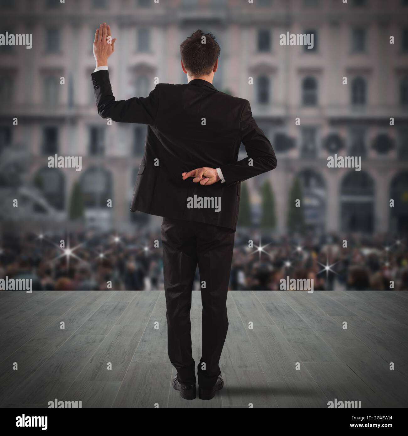 Man makes gesture with hand behind back Stock Photo - Alamy