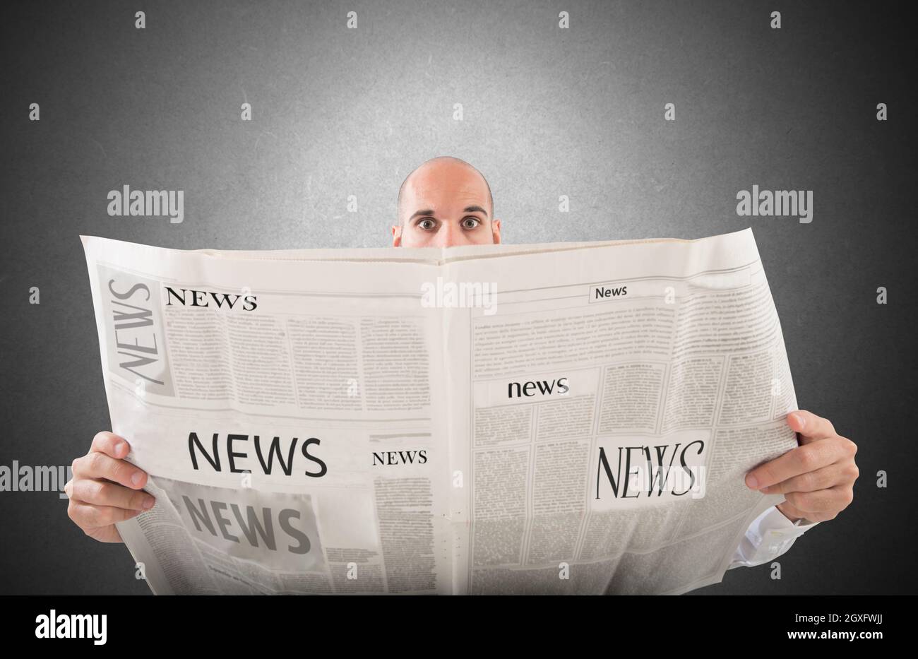 Man with startled expression reading a newspaper Stock Photo - Alamy