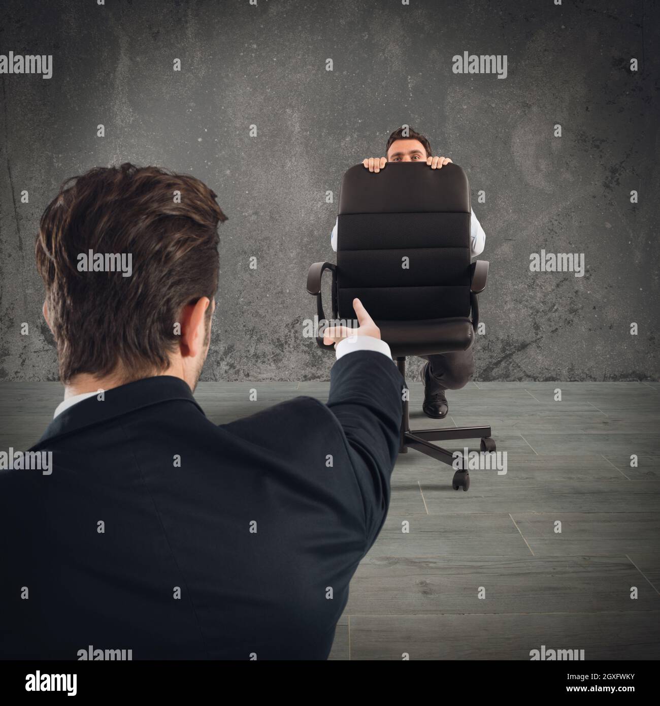 Employee hiding behind chair fearful of boss Stock Photo - Alamy