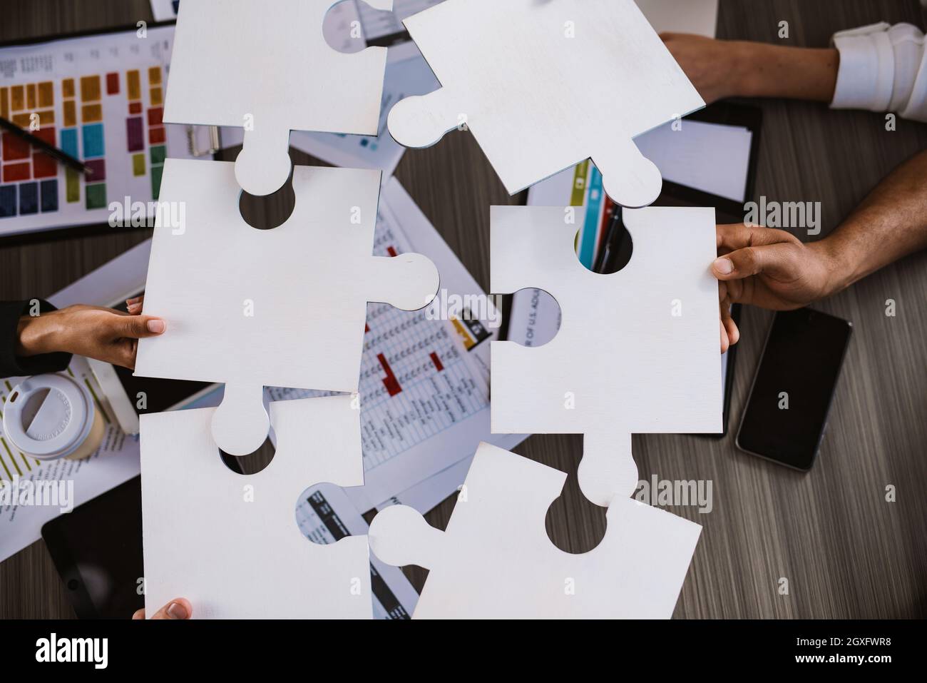 Businessmen working together to build a colored puzzle. Concept of ...