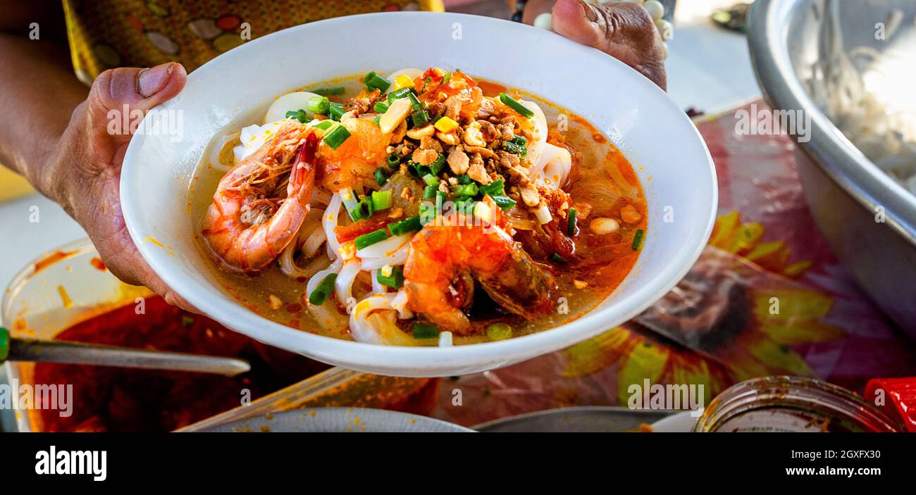 A bowl of Mi Quang is now served to a customer at Nghi Mi Quang ...