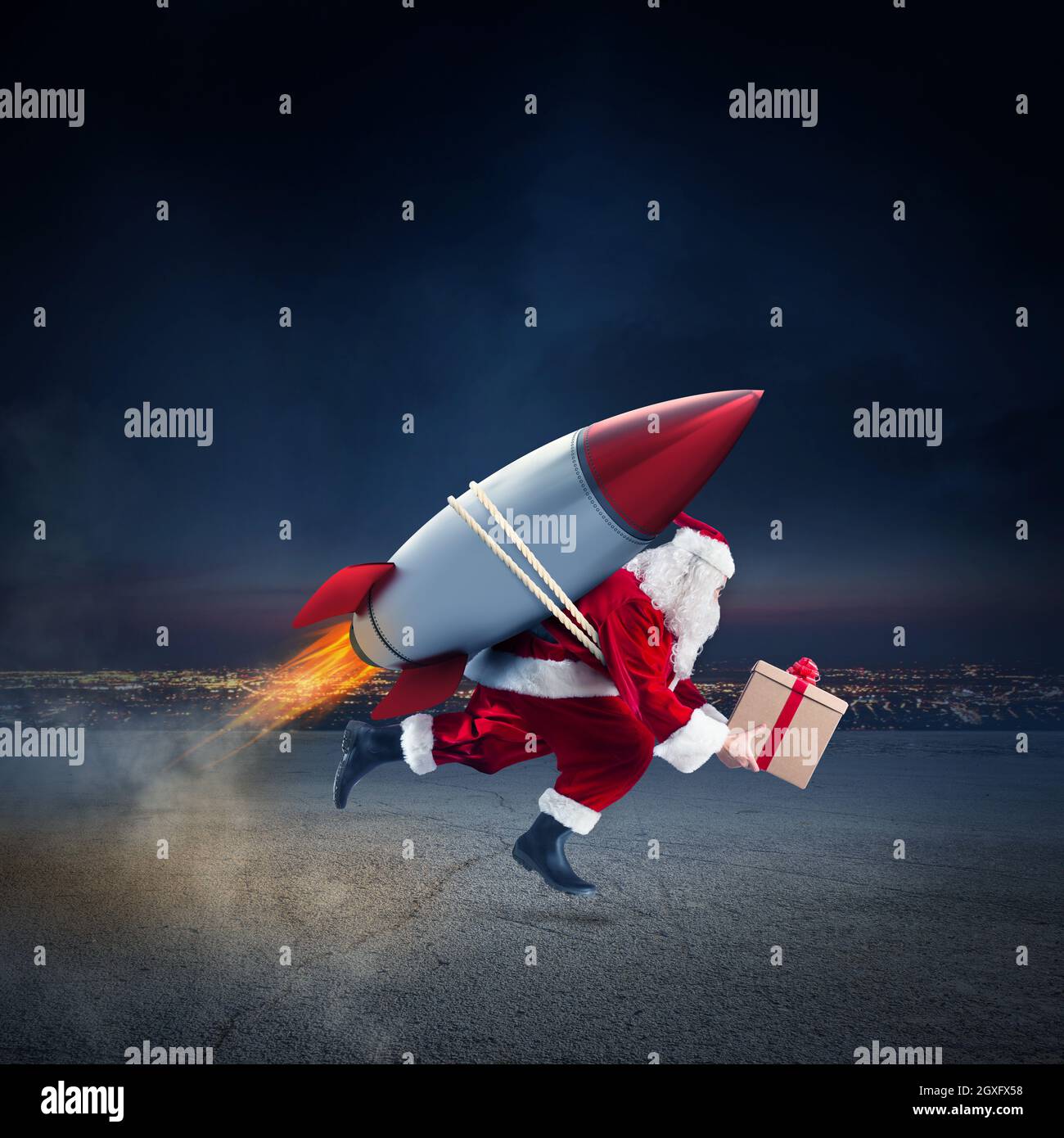 Santa Claus with gift box ready to fly with a rocket in the sky Stock ...