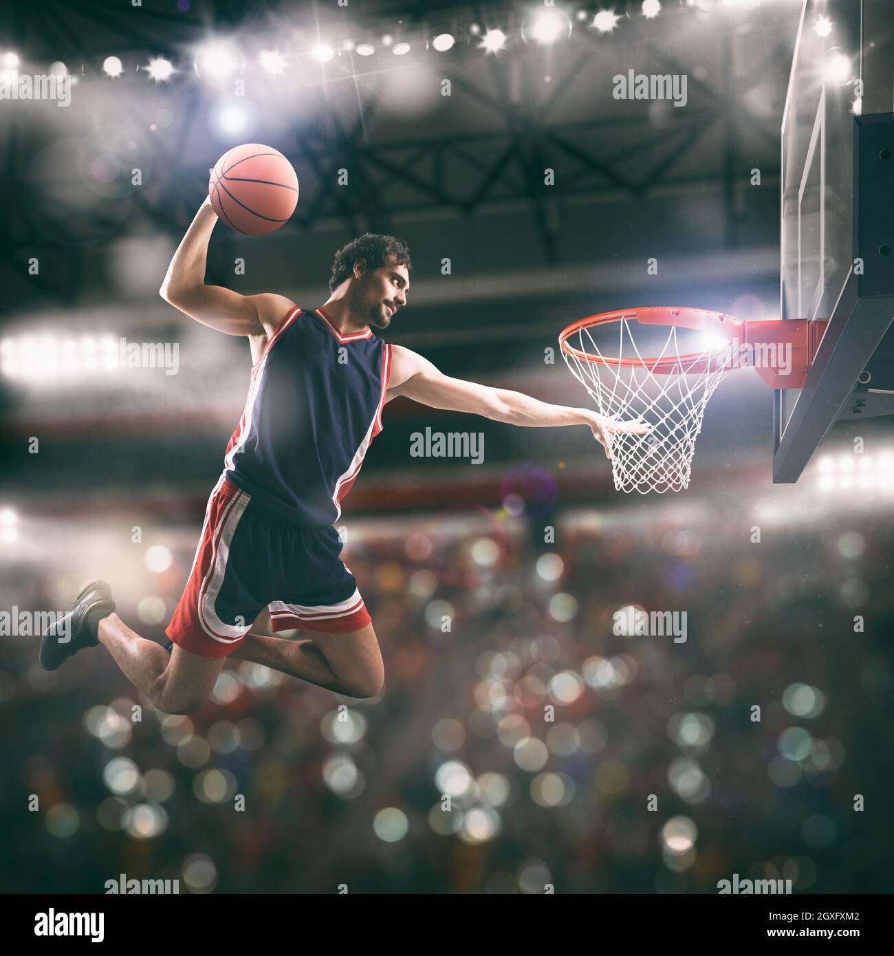 Basketball player slams dunk the ball to the basket Stock Photo - Alamy