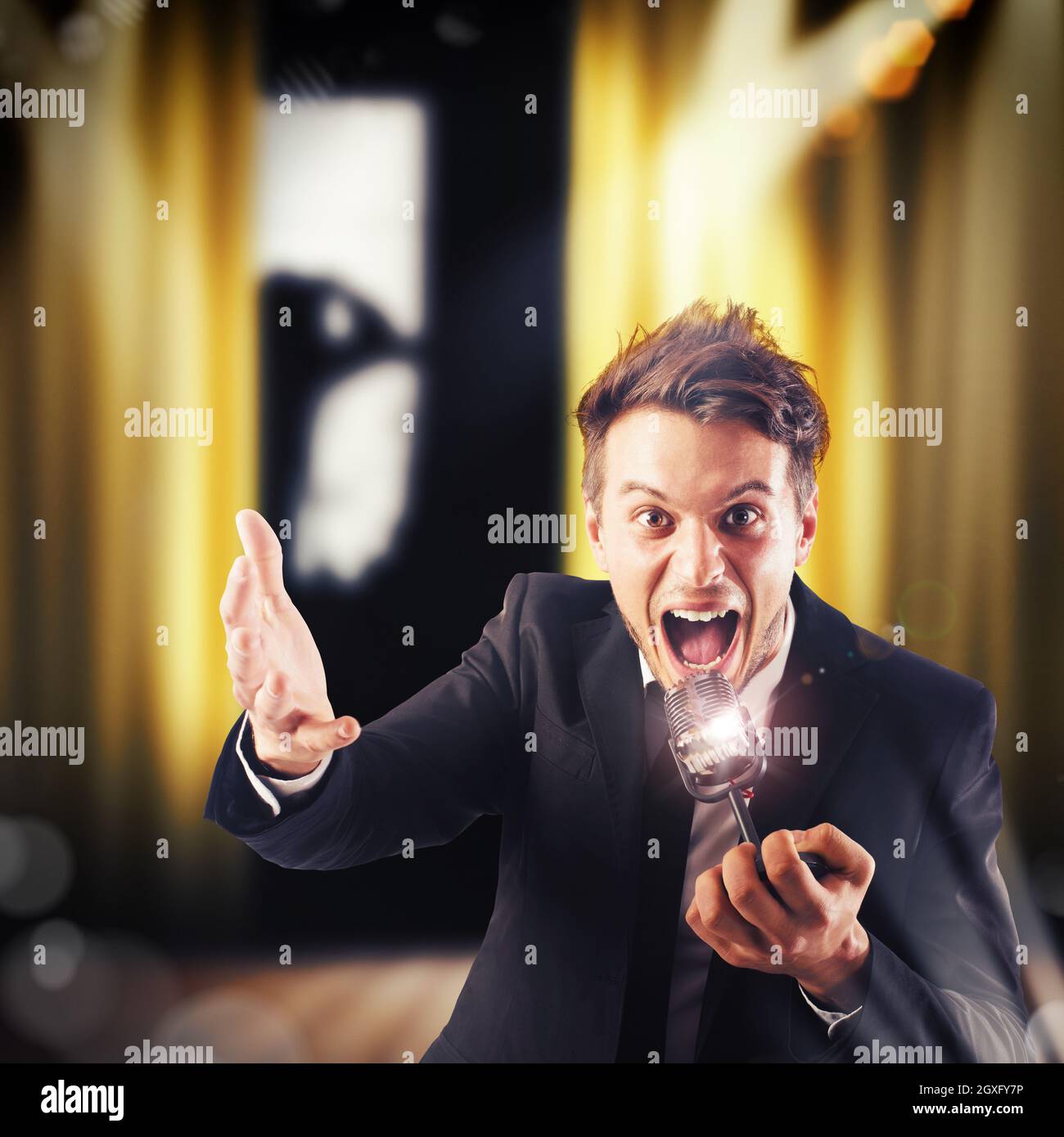 Man screaming at the microphone on theatre Stock Photo - Alamy
