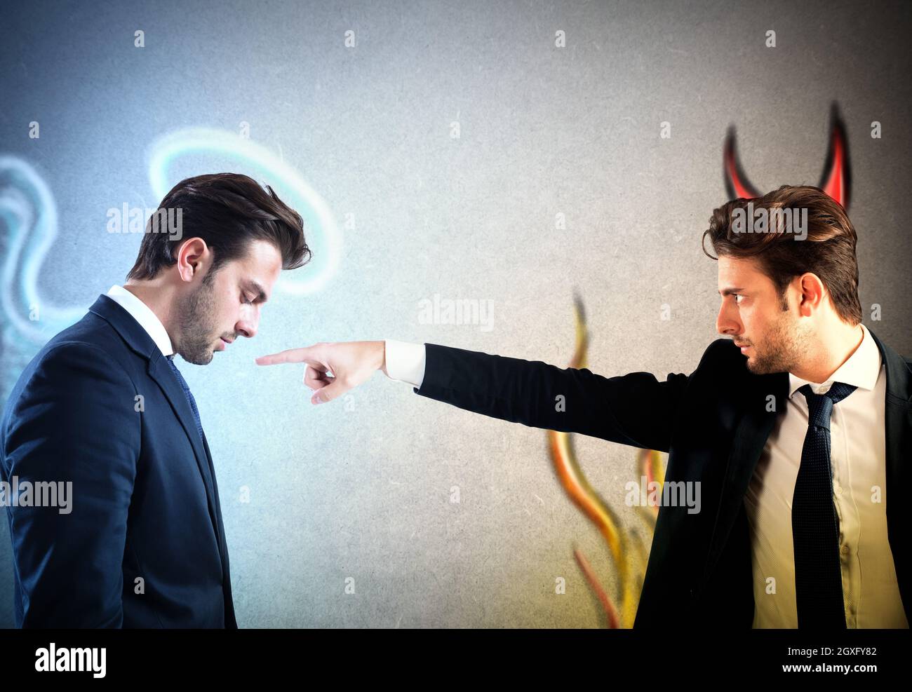 Man as devil accuses man as Angel Stock Photo - Alamy