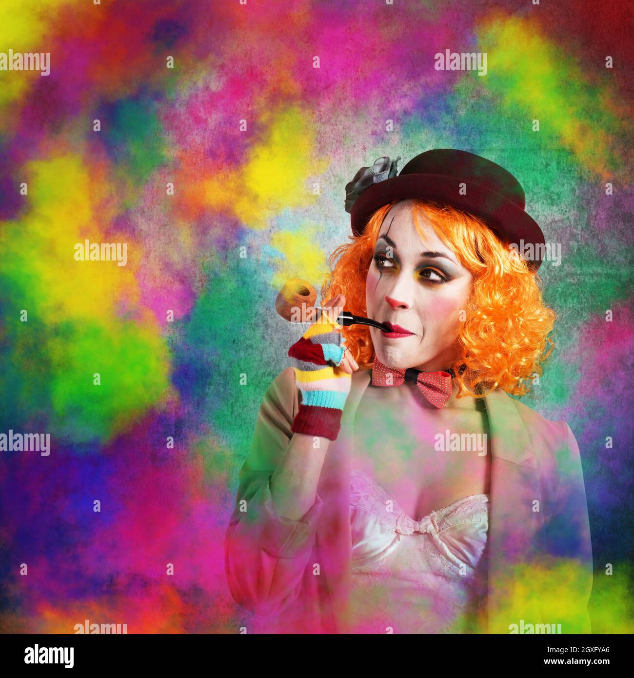 Clown smoking a pipe with colored smoke Stock Photo - Alamy