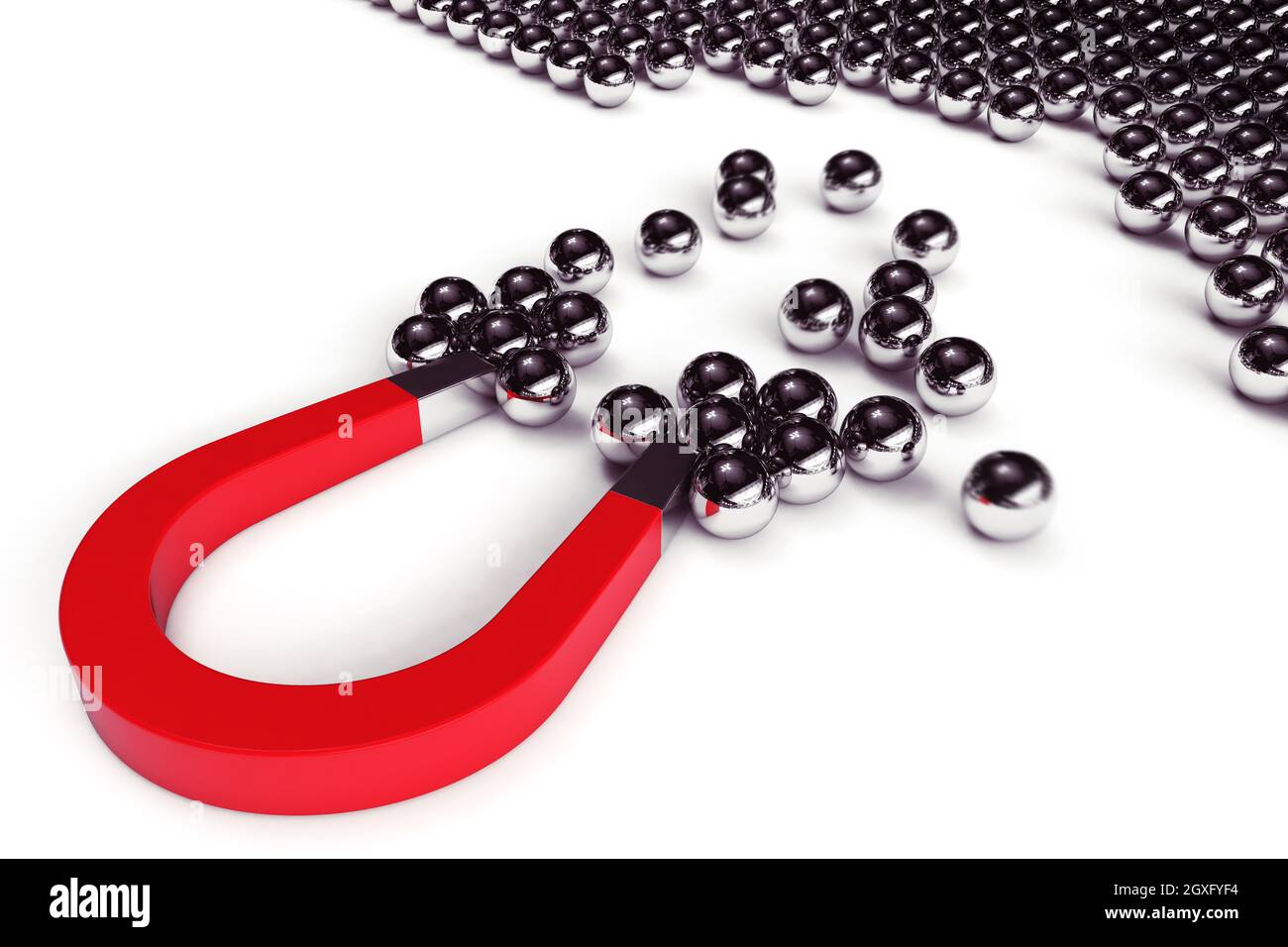 Magnet attracts steel balls from a pile Stock Photo - Alamy