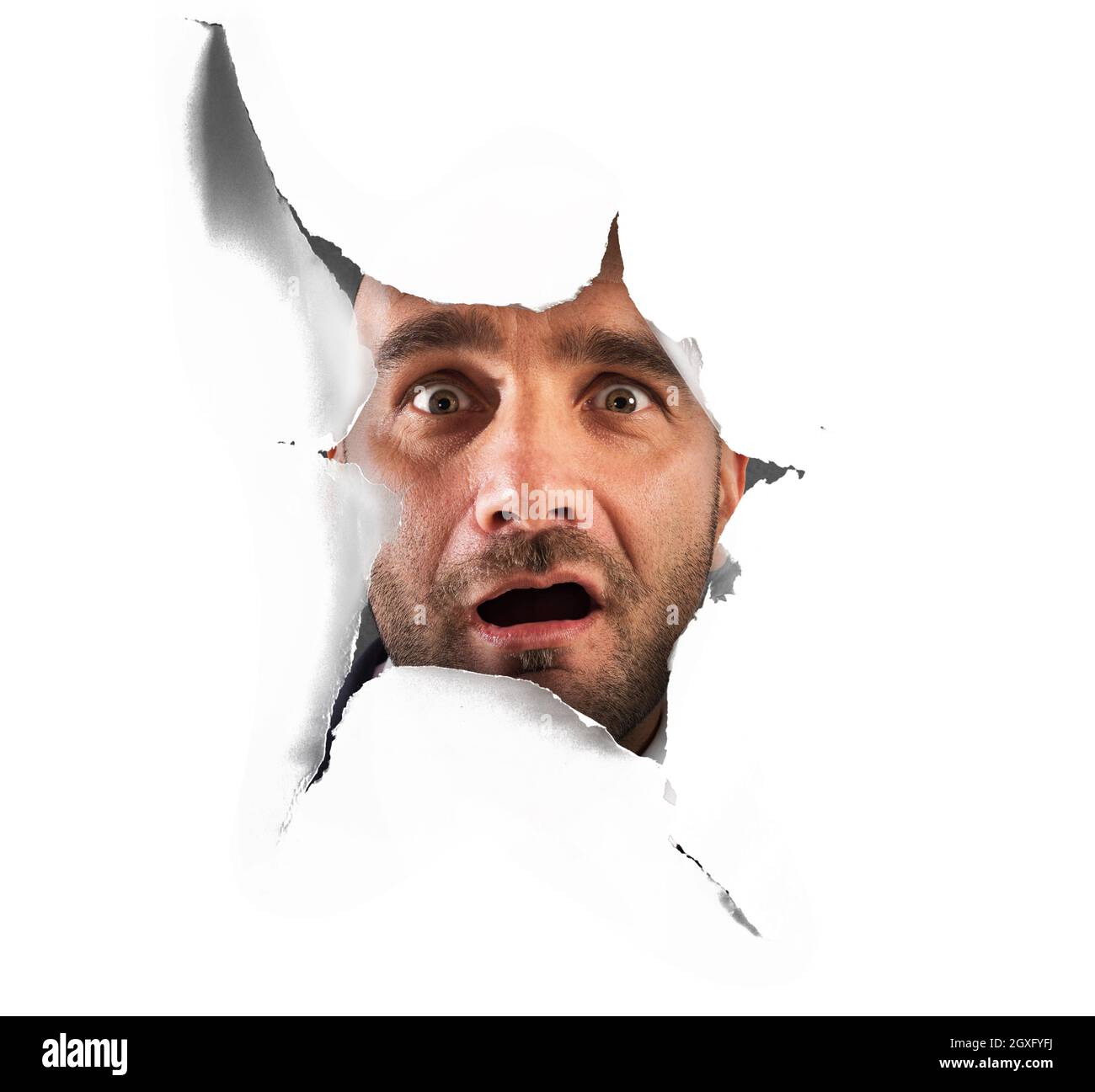 Man peeking through a hole something shocking Stock Photo - Alamy