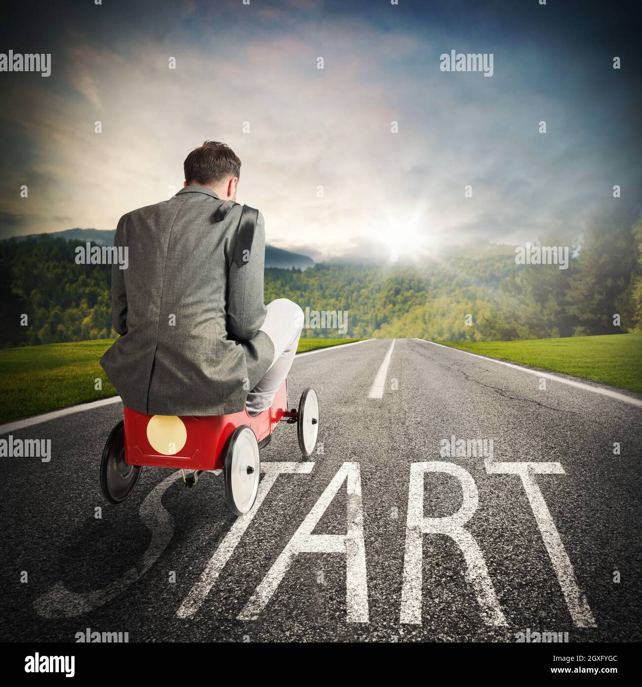 Businessman driving a small car for kids Stock Photo - Alamy