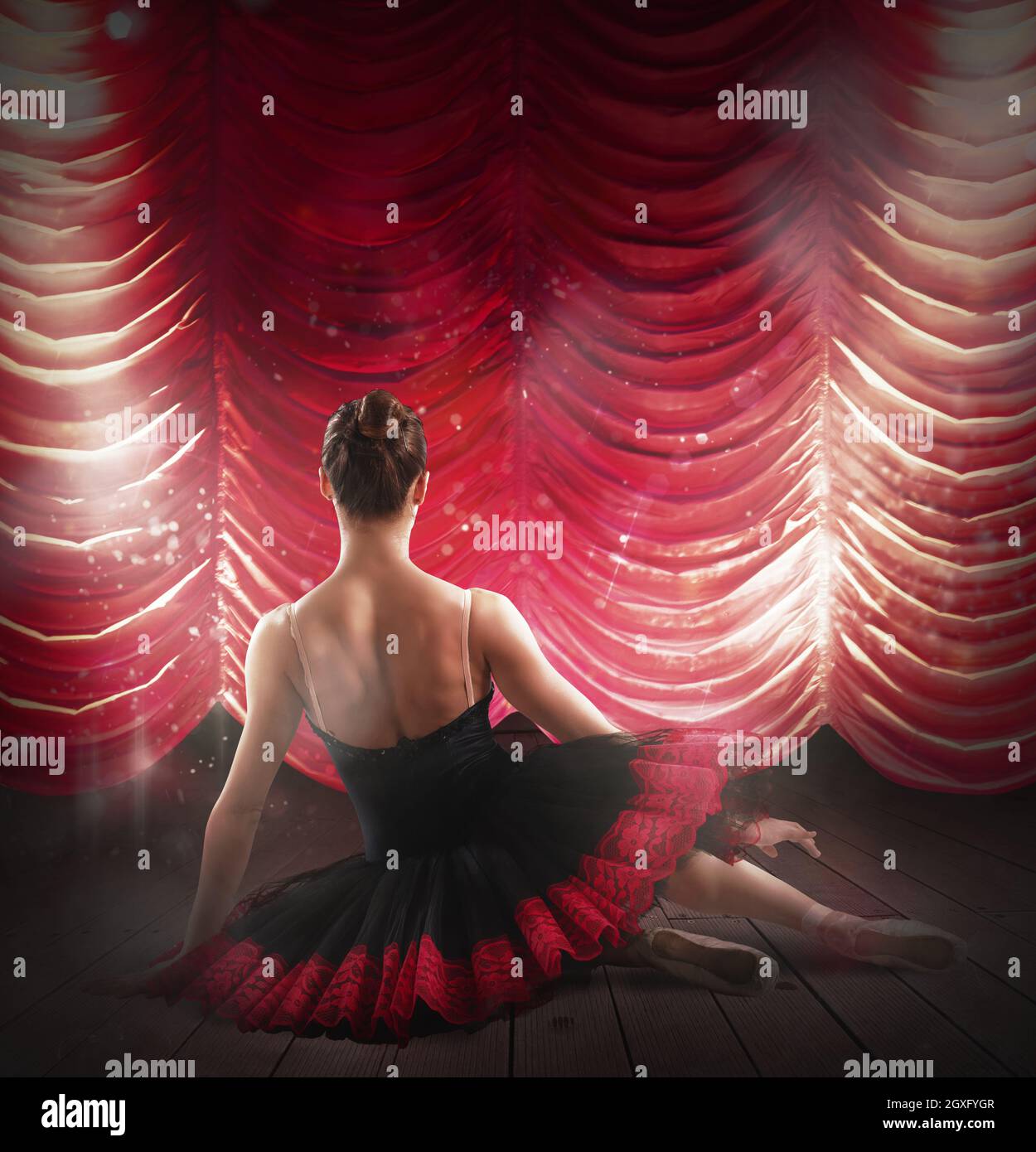 Dancer posing behind the red velvet curtains Stock Photo - Alamy