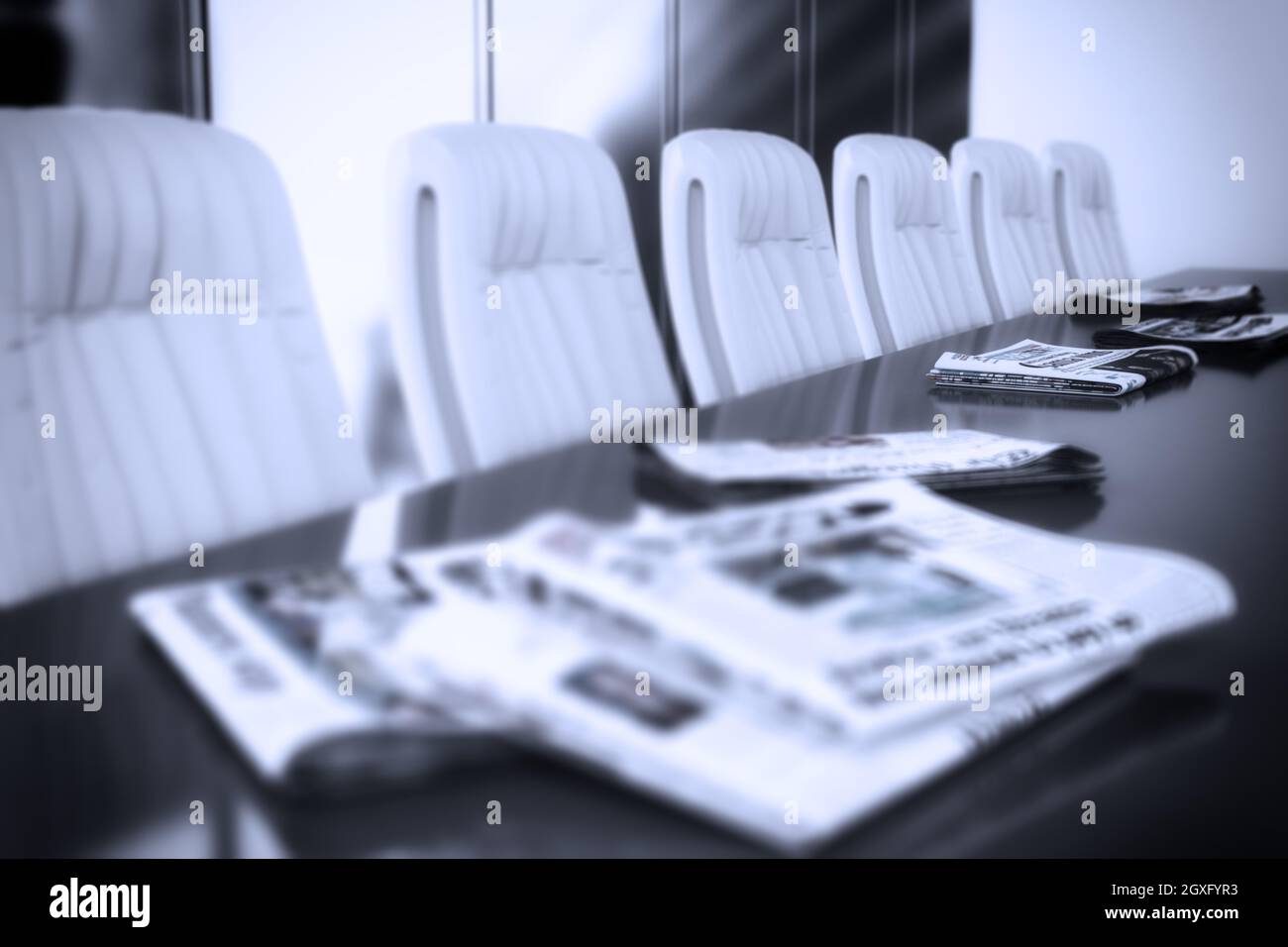 Meeting room with newspapers on the table Stock Photo - Alamy