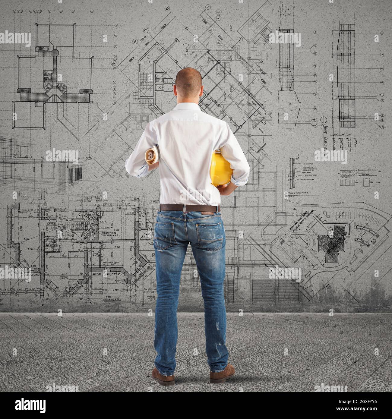 Architect looks at projects of a building Stock Photo - Alamy