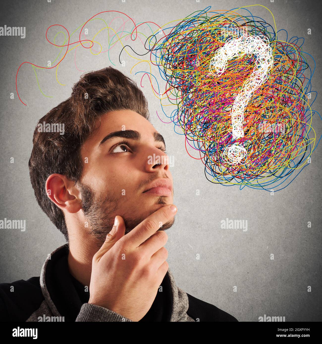 Boy with thoughtful expression and question mark Stock Photo - Alamy